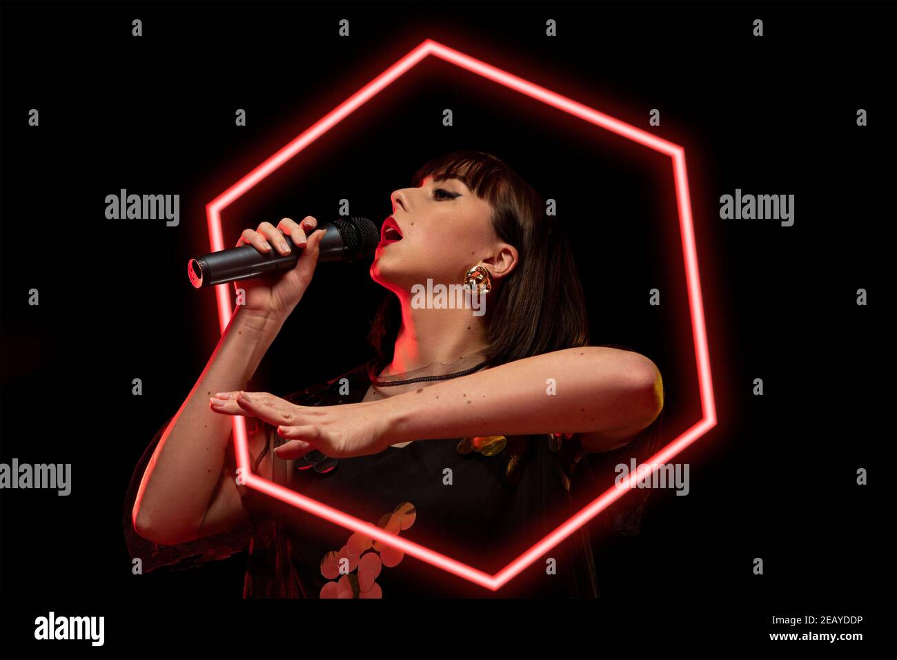 Caucasian female singer portrait isolated on black studio background in ...