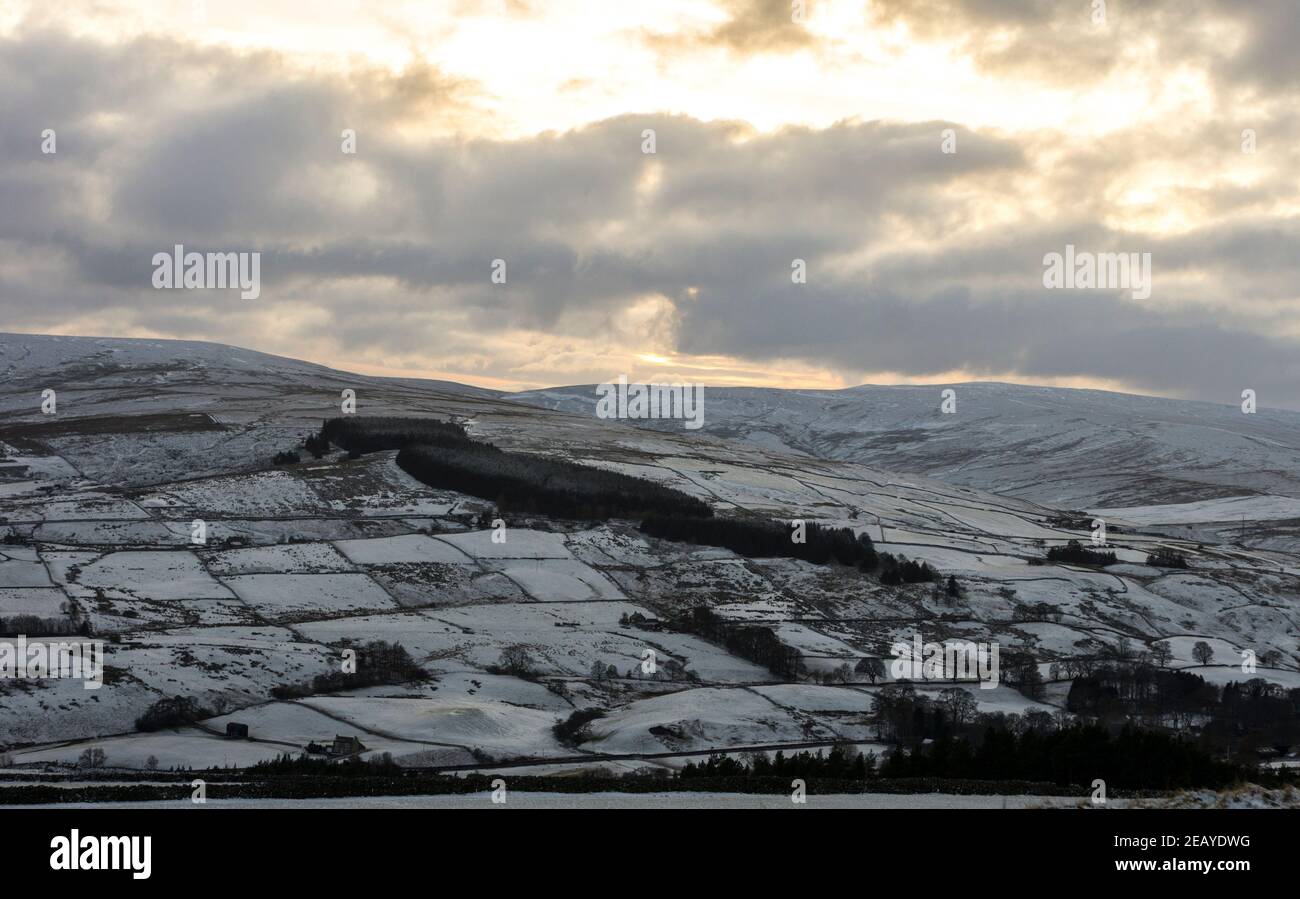 Snow covered hills against a warm late afternoon sky in Weardale ...
