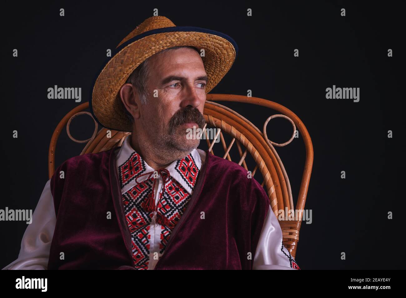 Nice portrait of Ukrainian country-man sitting in a wicker chair ...