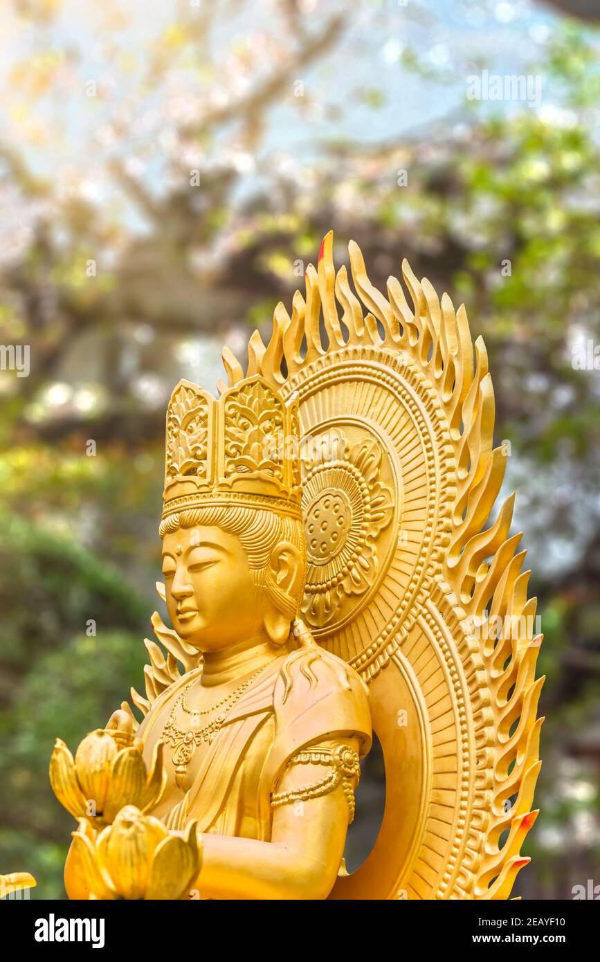 tokyo, japan - april 05 2020: Close up on a golden statue of the buddha ...