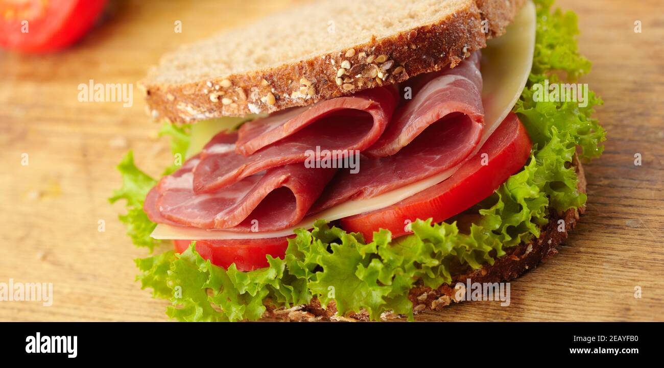 fresh deli sandwich with tomatoes, swiss chees, lettuce Stock Photo - Alamy