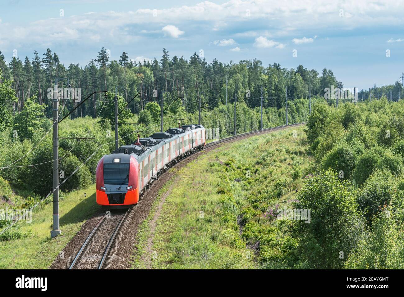 Passenger train approaches to the station at summer day time Stock ...