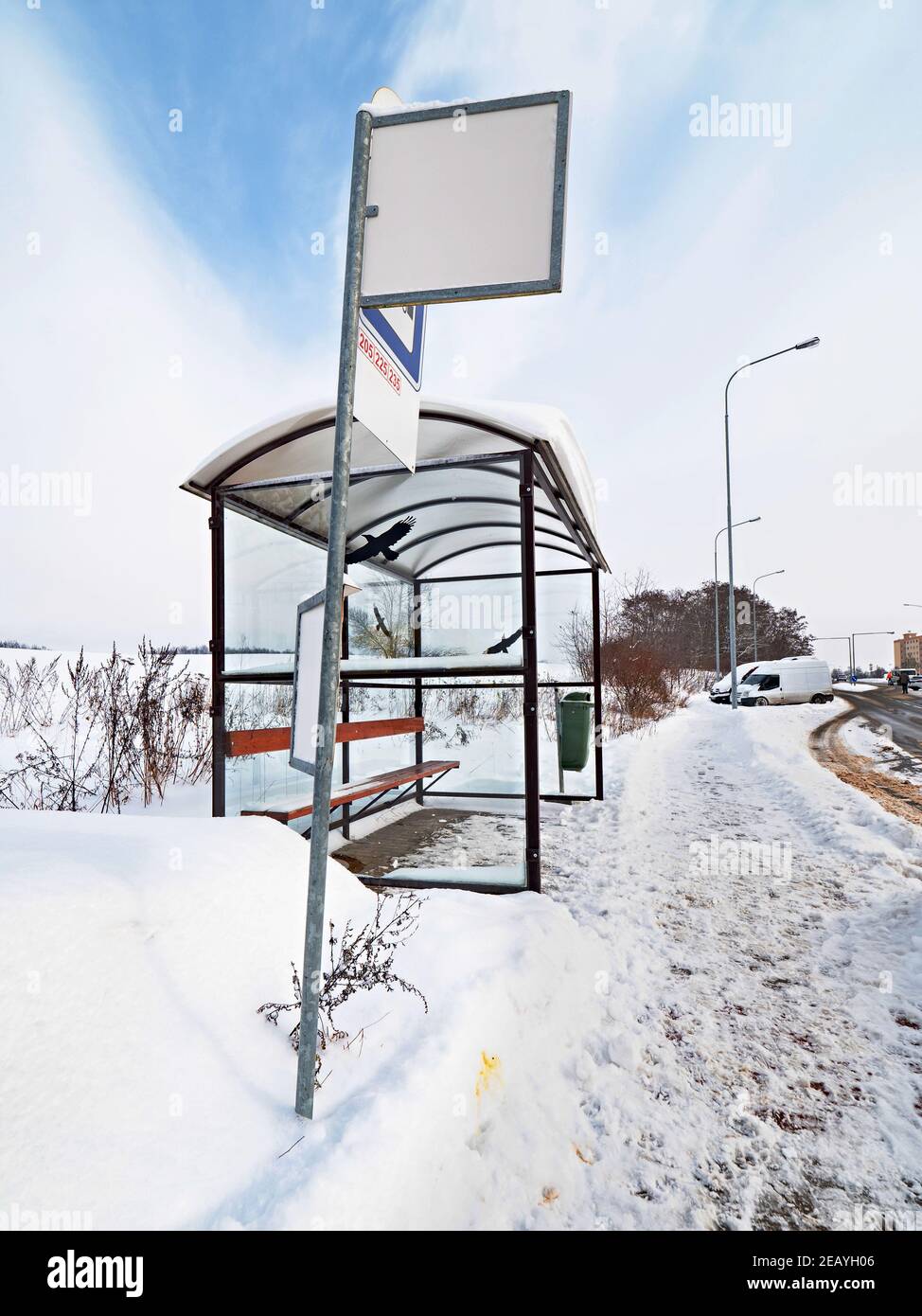The deep snow and snowdrift around glassy bus station. Shine of snow ...
