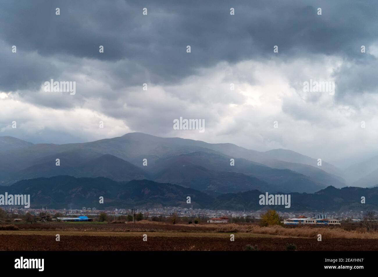 Beautiful natural background with little city under the skyscape and ...