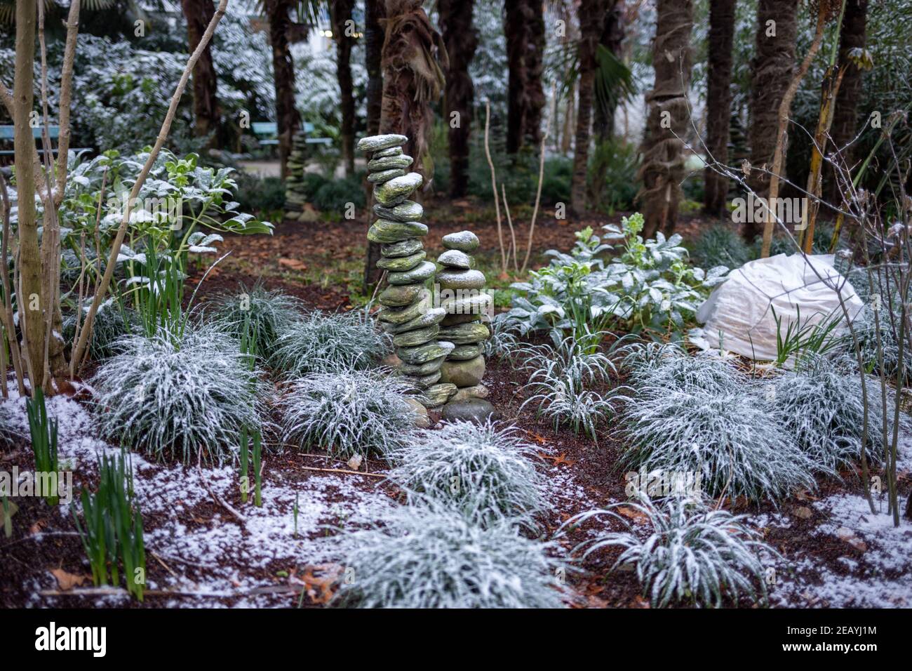 a pile of rocks in garden covered with snow Stock Photo - Alamy