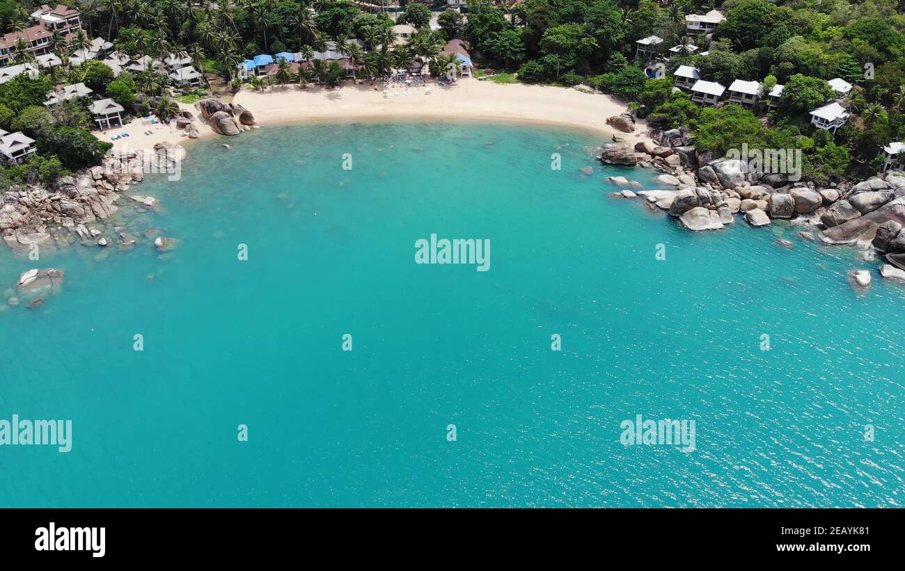 Small houses on tropical island. Tiny cozy bungalows located on shore ...