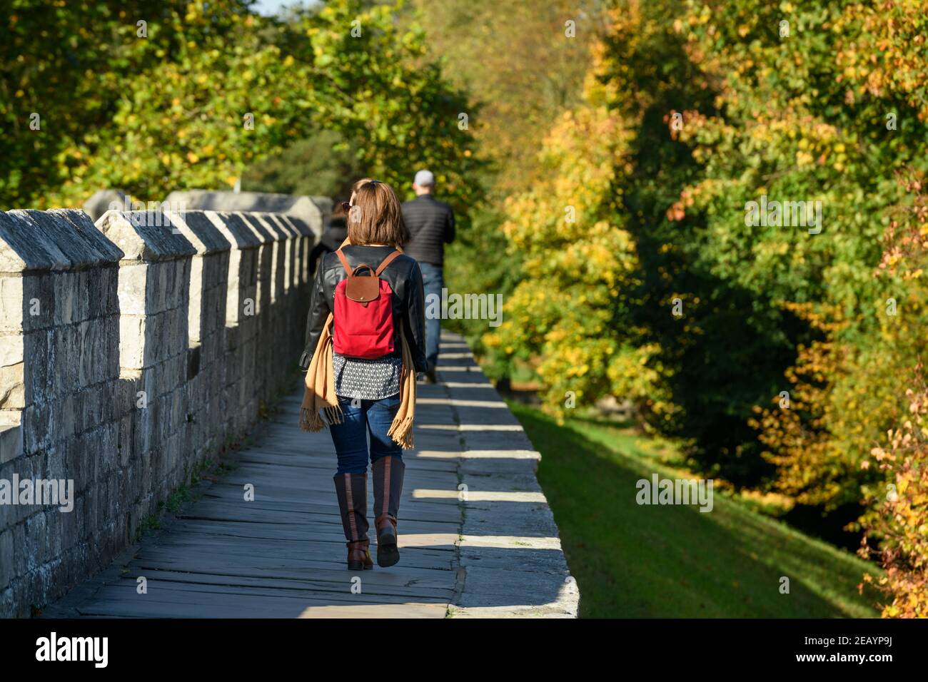 People walking on scenic historic walkway on medieval city walls (old ...