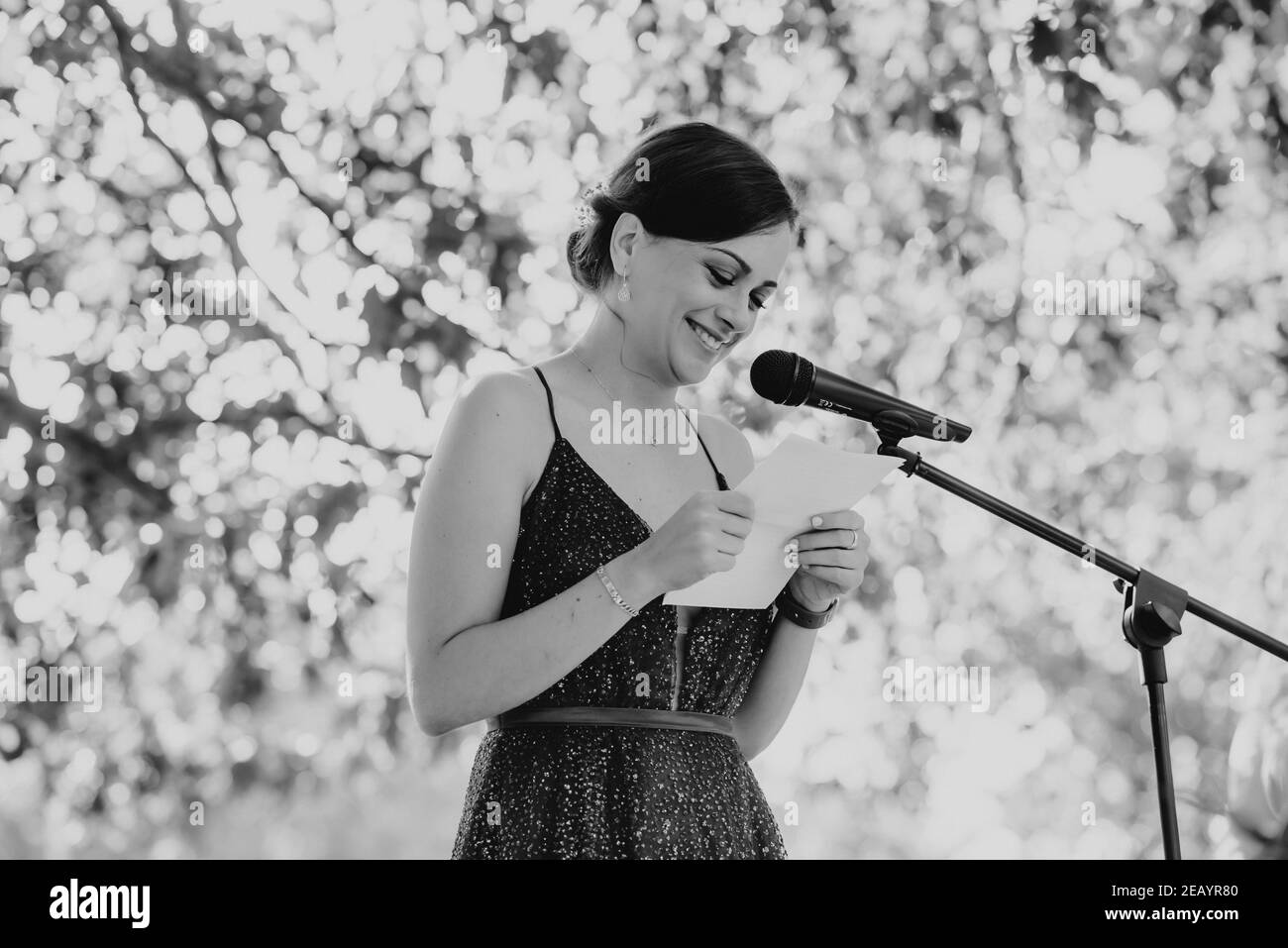 Young woman reading a speech on an event Stock Photo - Alamy