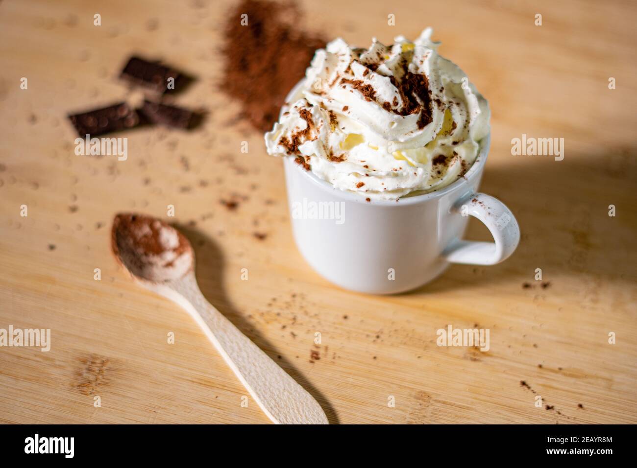 Closeup shot of a cup of coffee with whipped cream cocoa powder and ...