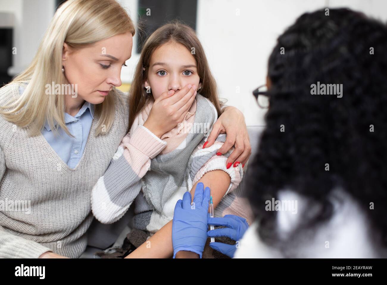 Pediatrician and patient at home. Close up of pretty teen girl, scared ...