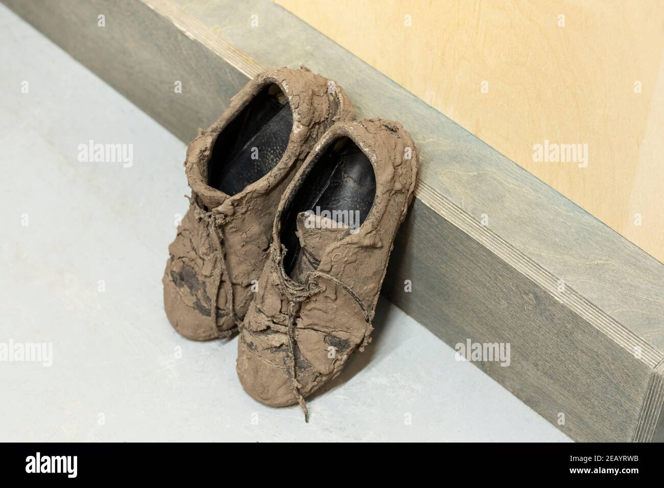 Dirty dried muddy and messy sneaker shoes totally covered with mud ...
