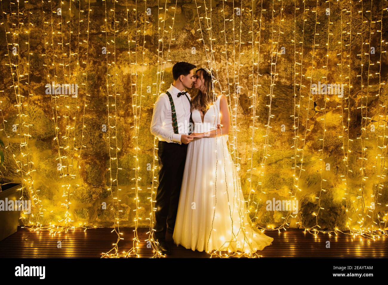 Just married couple at night with lots of yellow lights Stock Photo - Alamy