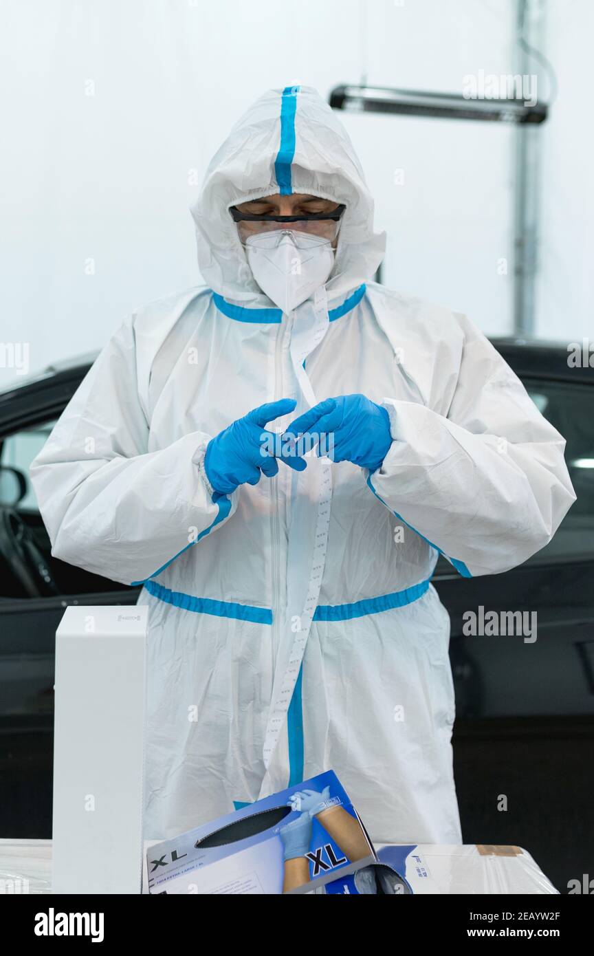 Portrait of nurse wearing protective suit and personal protection ...