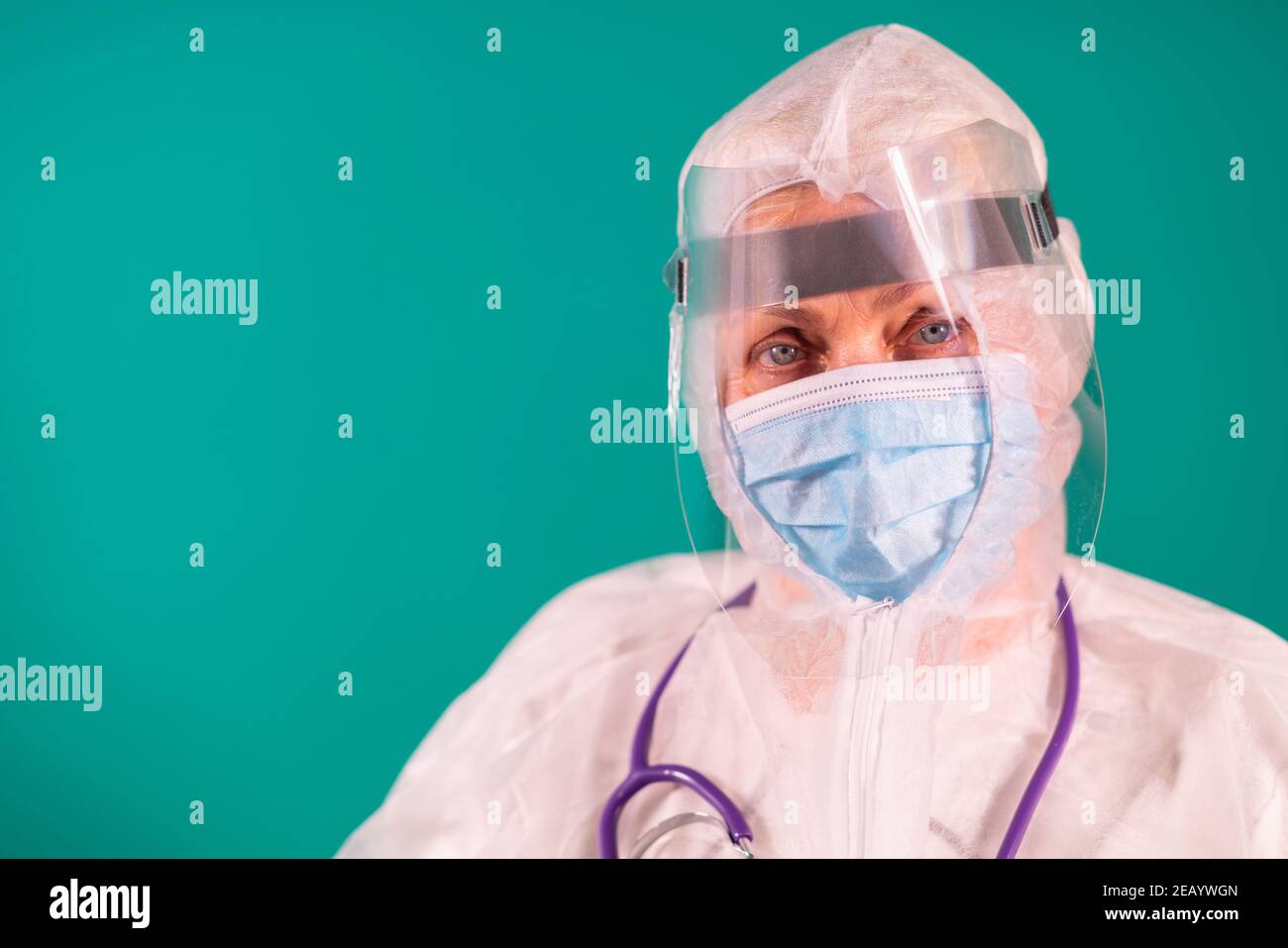 Doctor with a face shield in PPE suit uniform with stethoscope on the ...