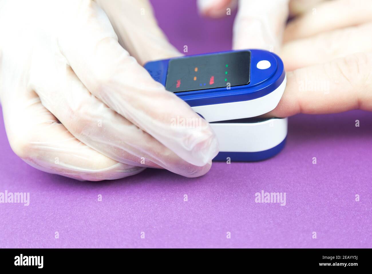 A doctor wearing gloves measures the oxygen level in the blood. Close ...