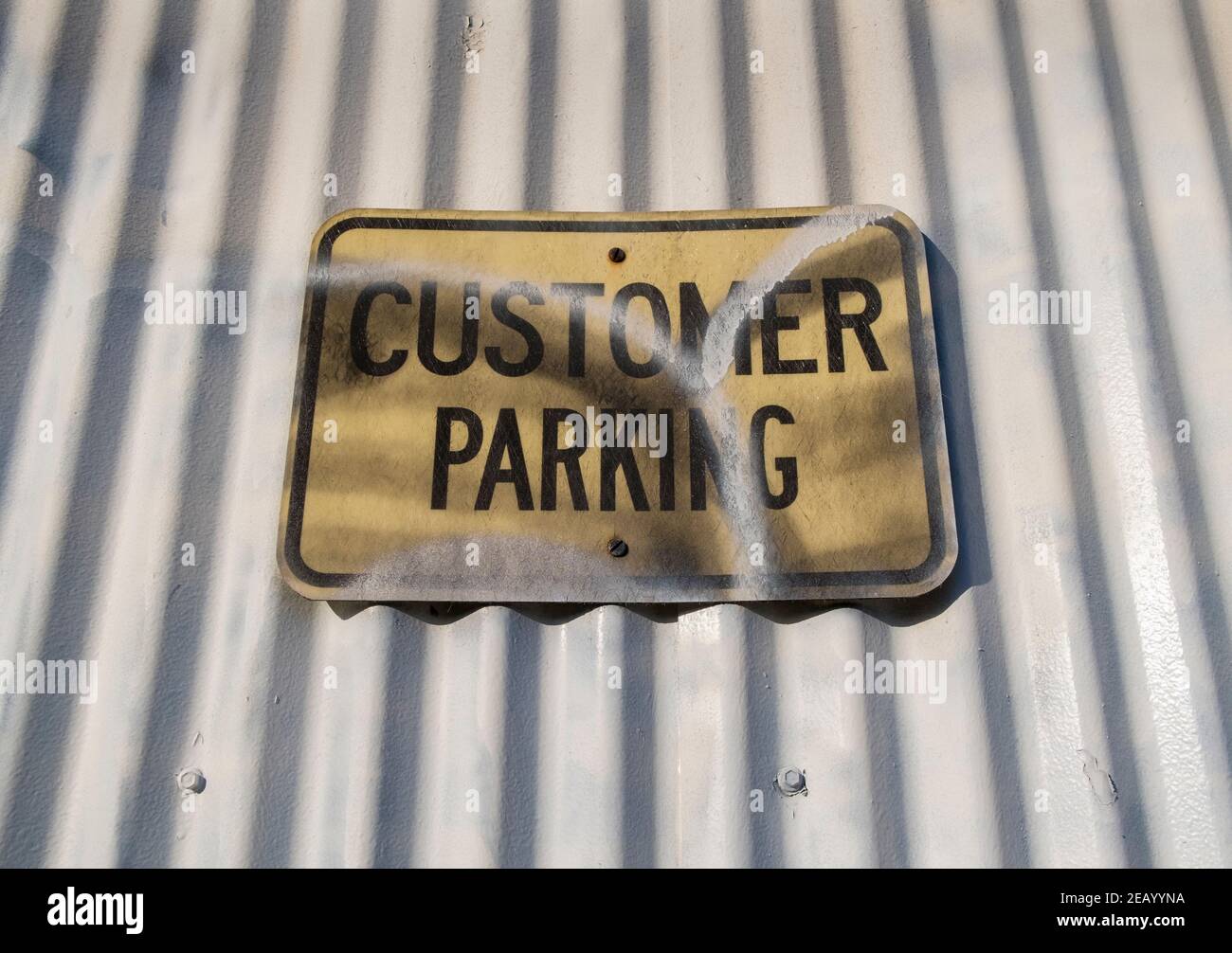 Customer Parking sign on warehouse exterior Stock Photo - Alamy