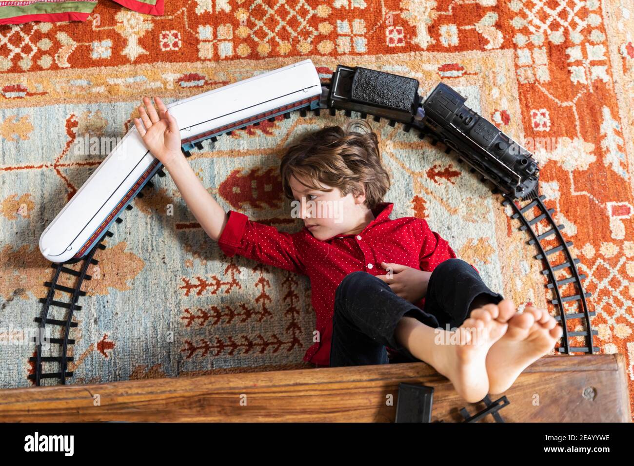 overhead view of young boy playing with his train Stock Photo - Alamy