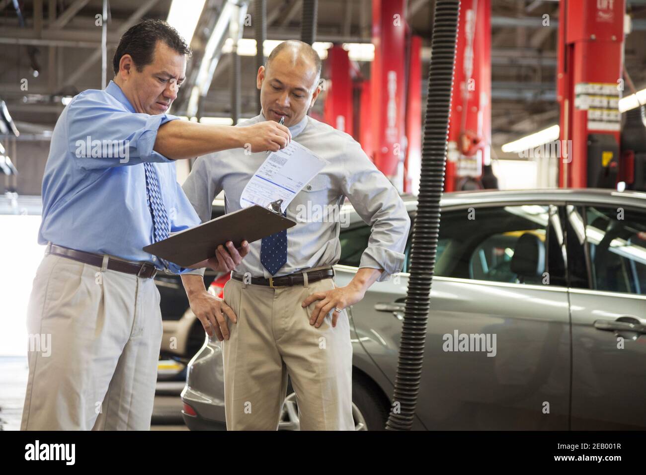 Mechanic talking to a car owner hi-res stock photography and images - Alamy