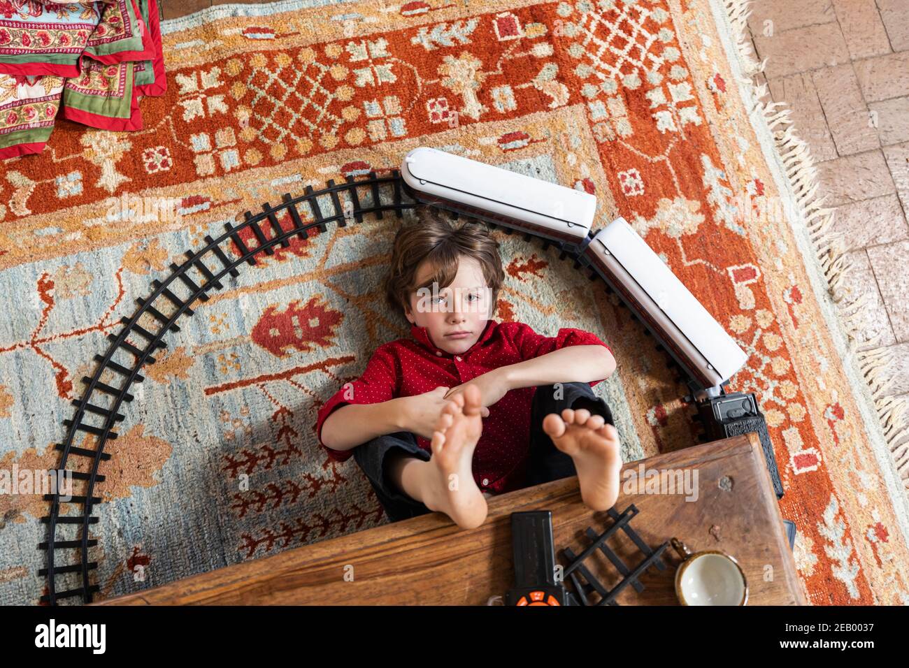 overhead view of young boy playing with his train Stock Photo - Alamy