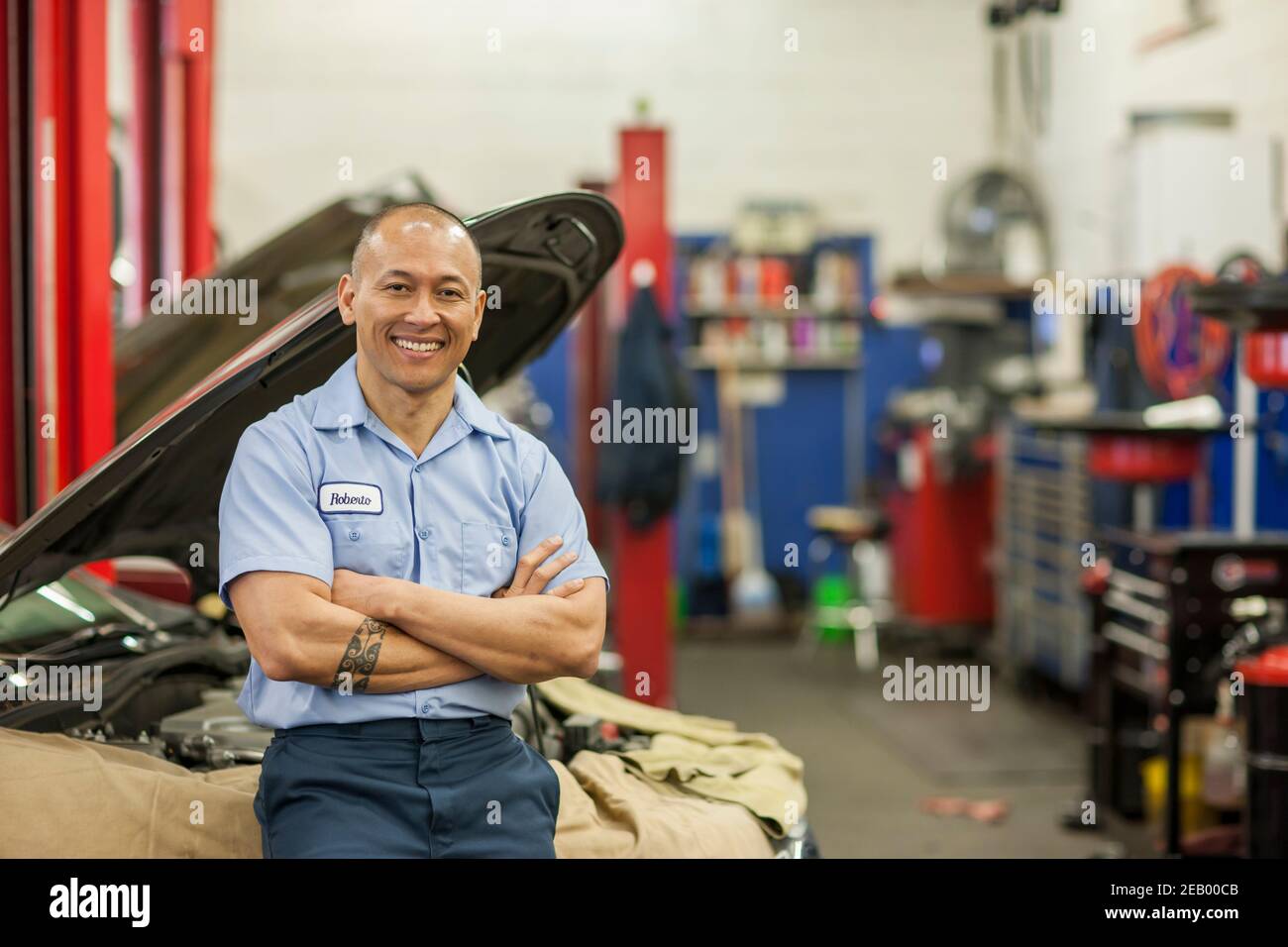 Portrait of Pacific Islander car mechanic in auto repair shop Stock ...