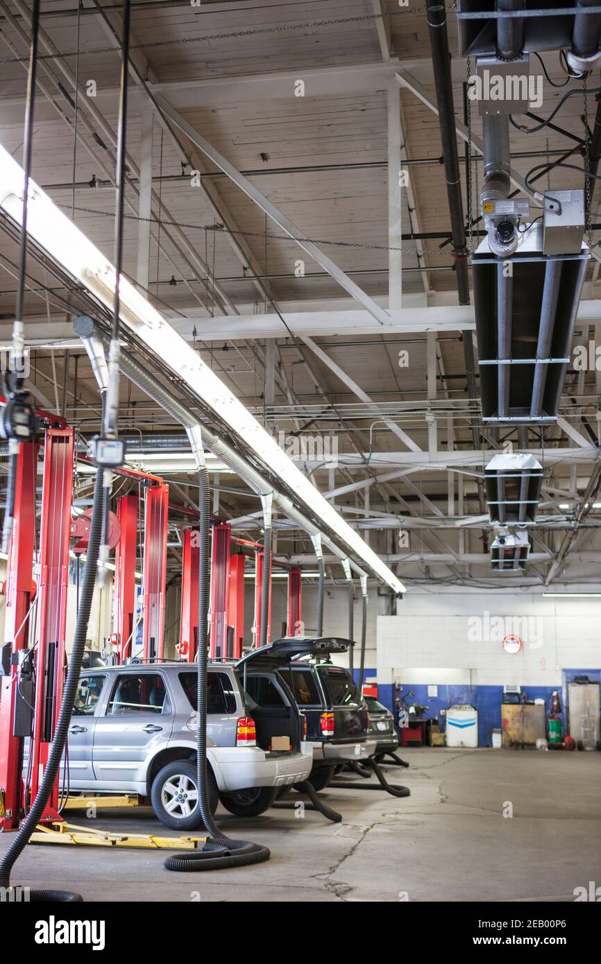 Rows of cars and trucks in auto repair shop Stock Photo - Alamy