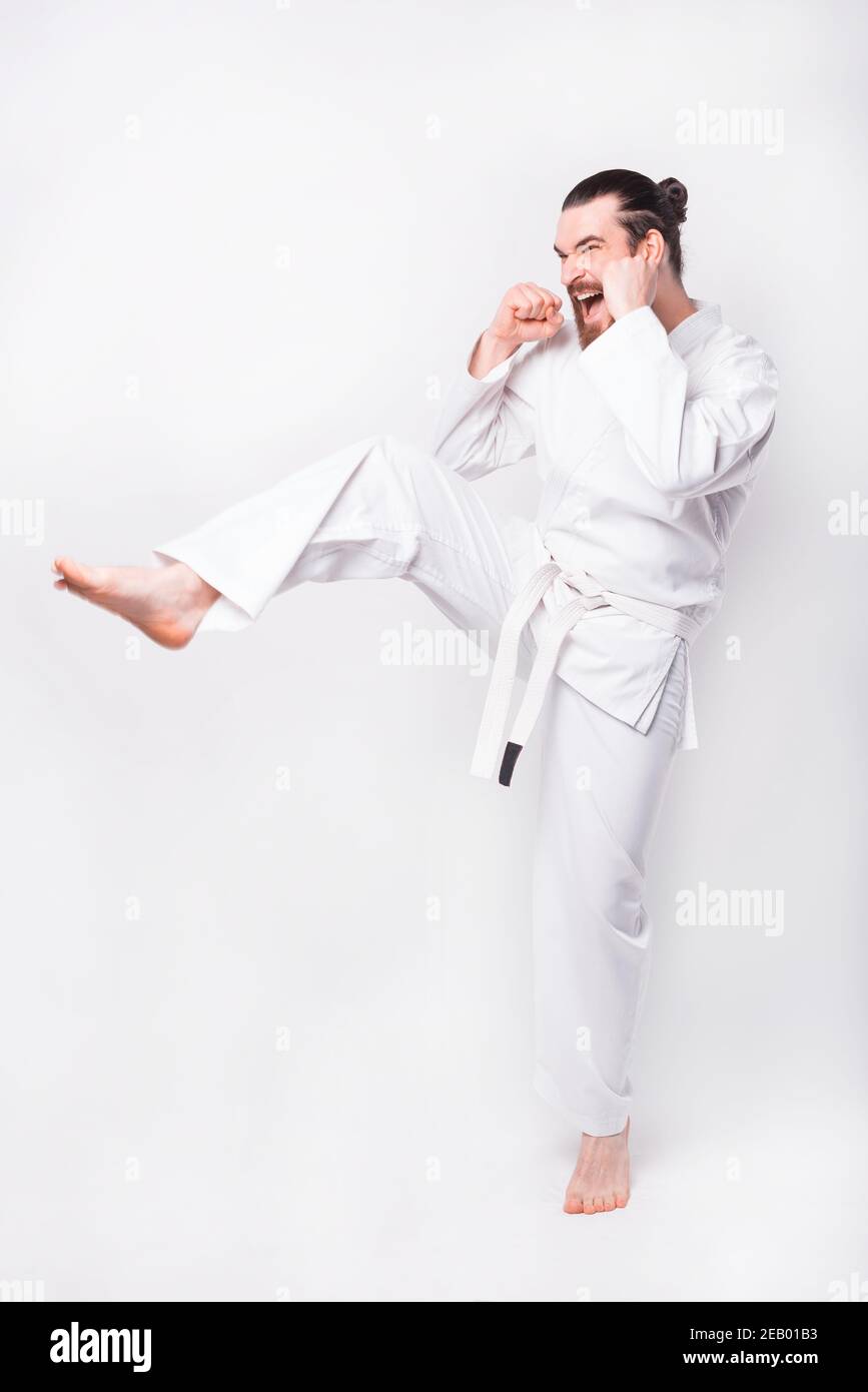 Photo of man practicing taekwondo and making a kick with leg Stock ...