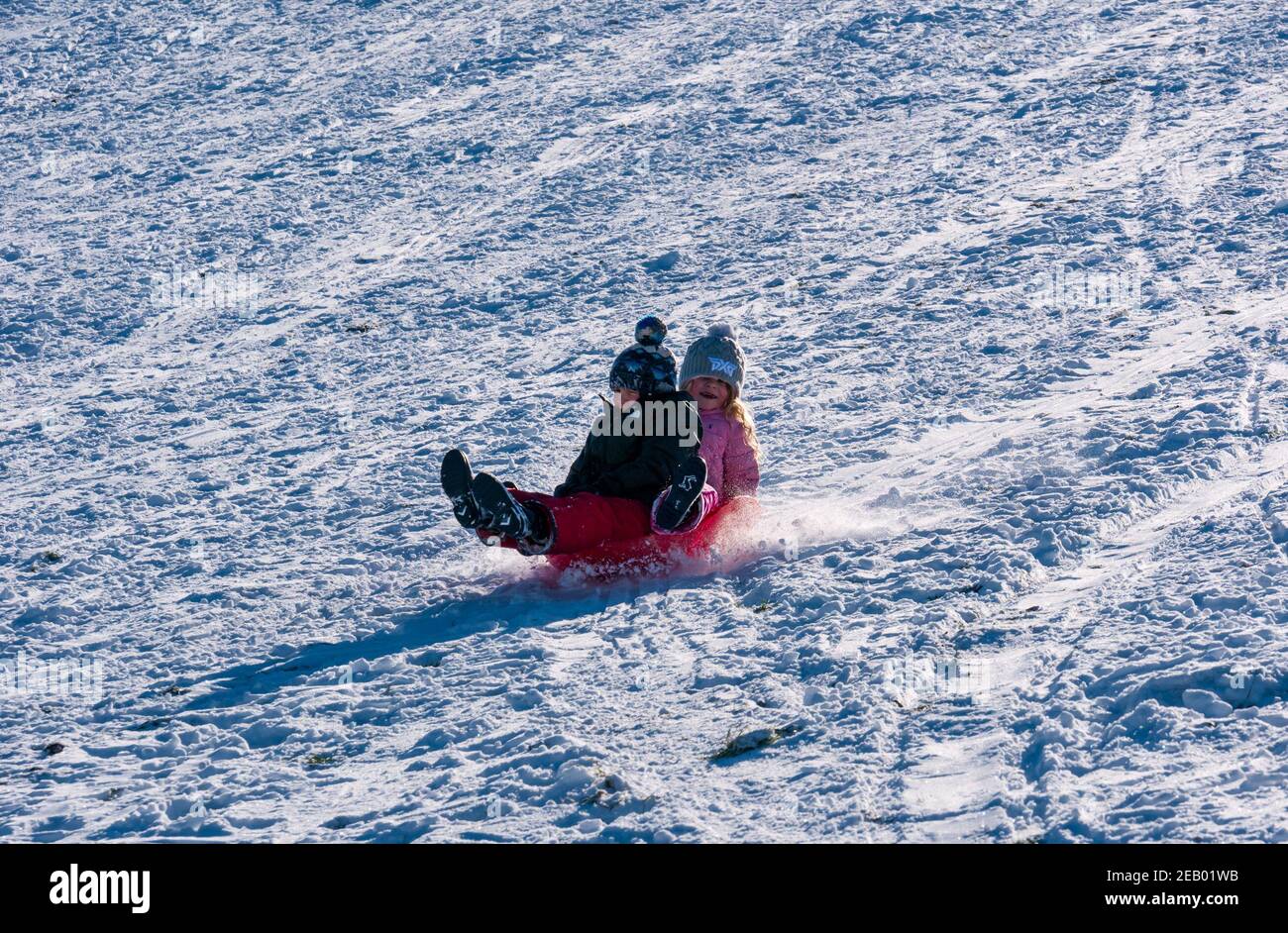 Boy sledging down a snowy hill hi-res stock photography and images - Alamy