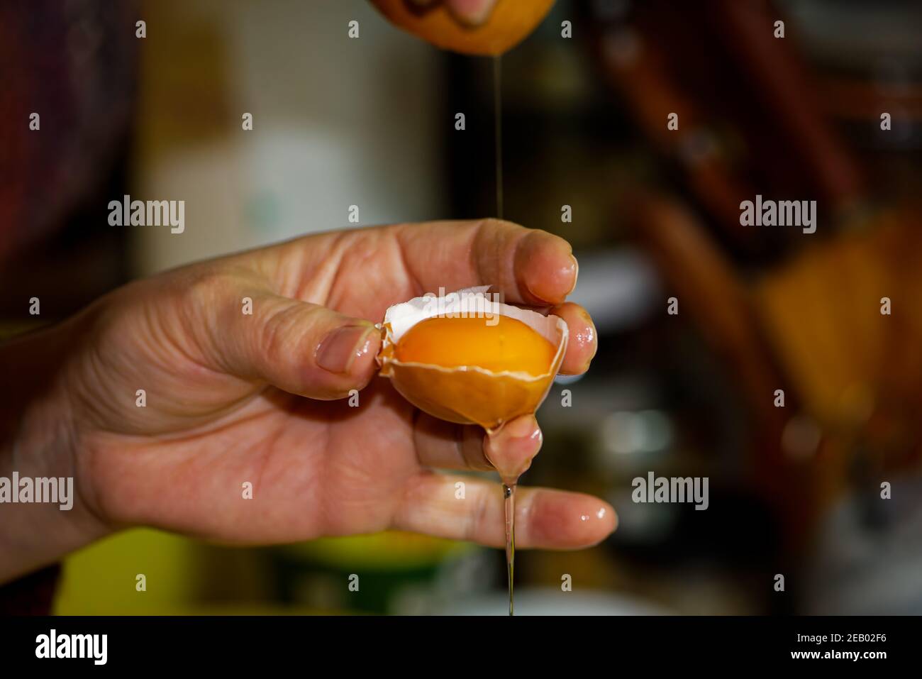 Egg and egg shell in a human hand, cooking with eggs in the kitchen ...