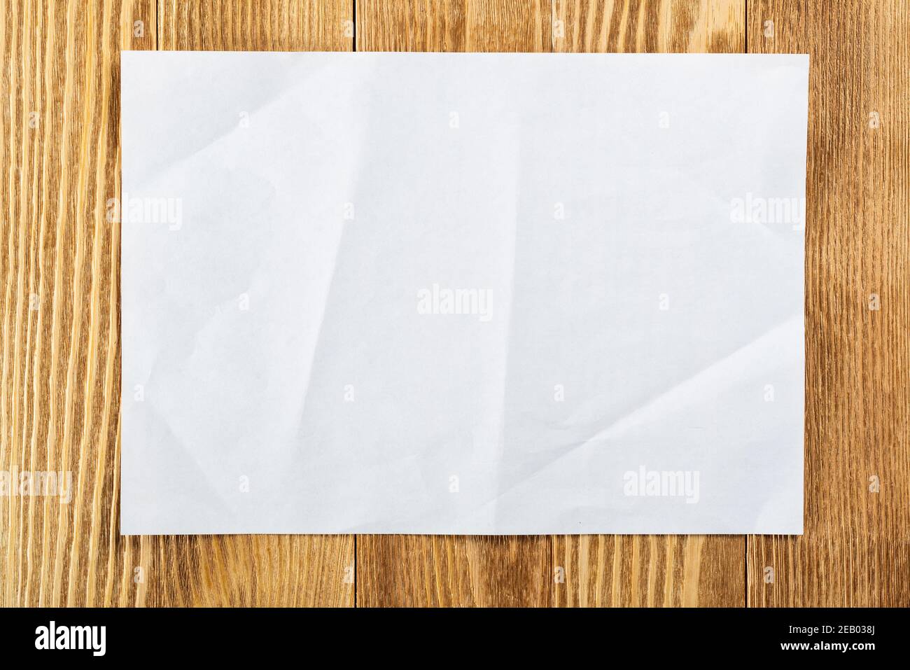 Flat lay wooden table with paper sheet Stock Photo - Alamy
