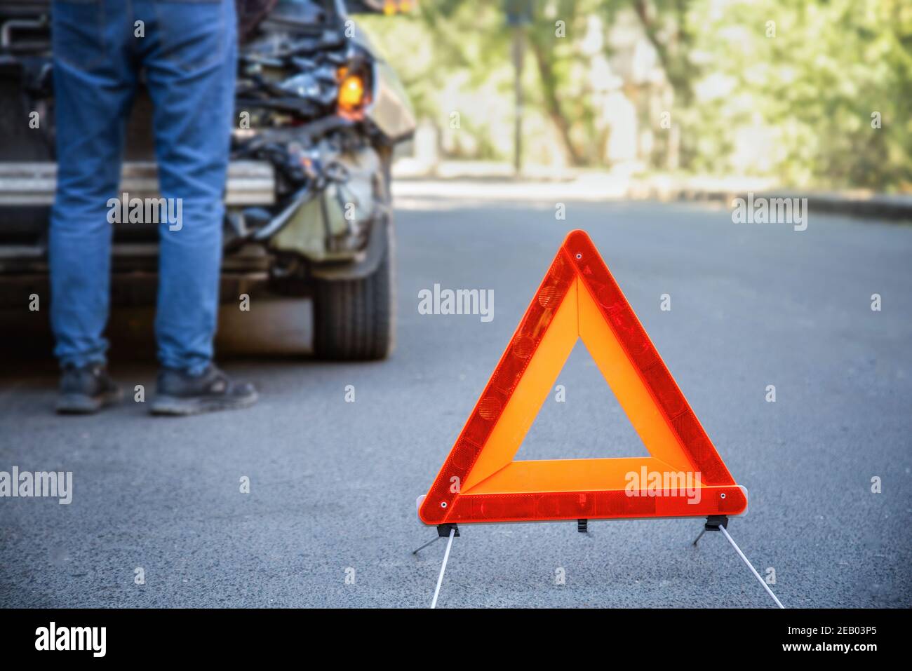 Red emergency stop triangle sign afore Destroyed car in car crash ...