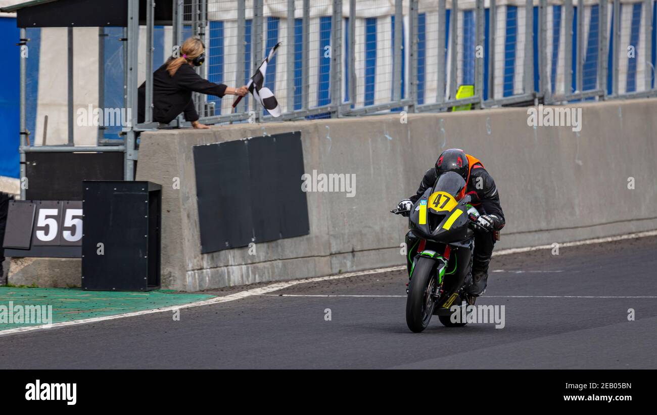 A shot of a racing motorbike as it circuits a track Stock Photo - Alamy