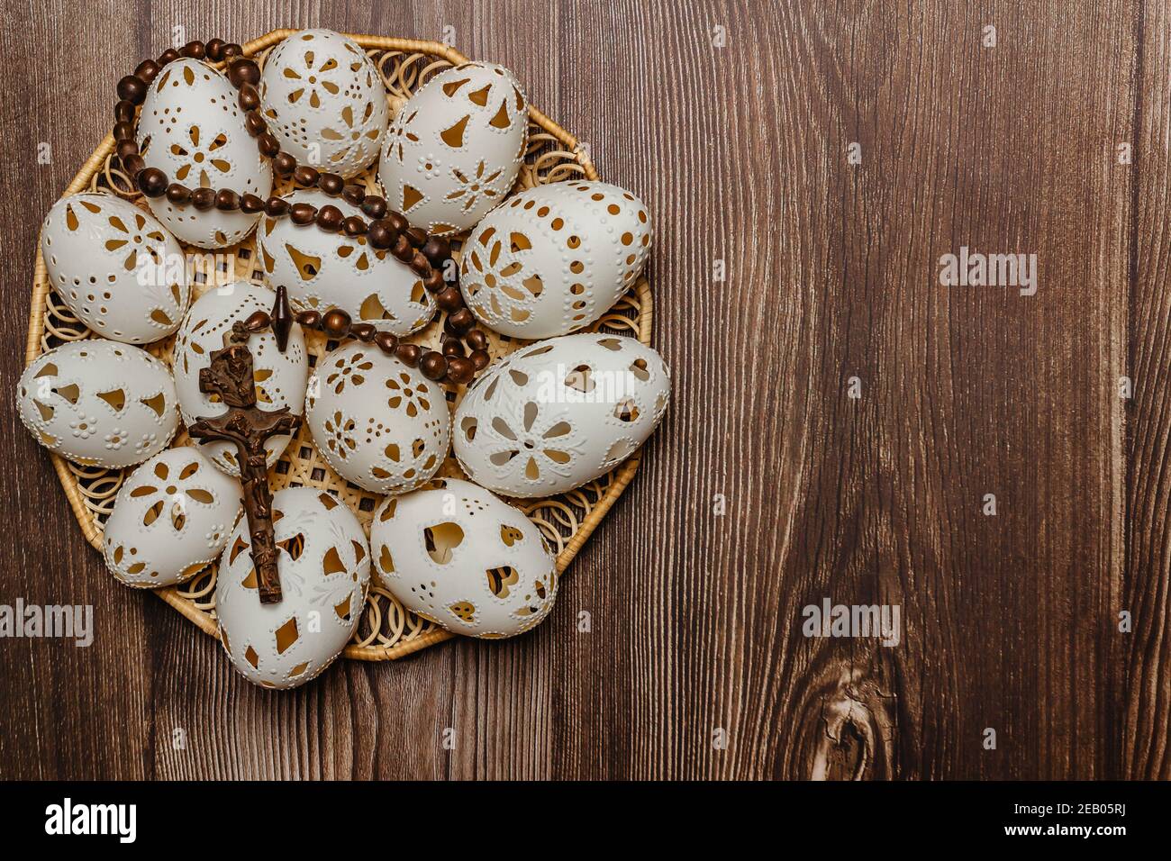 Happy Easter.White hand made Easter eggs with crucifix in wooden basket ...