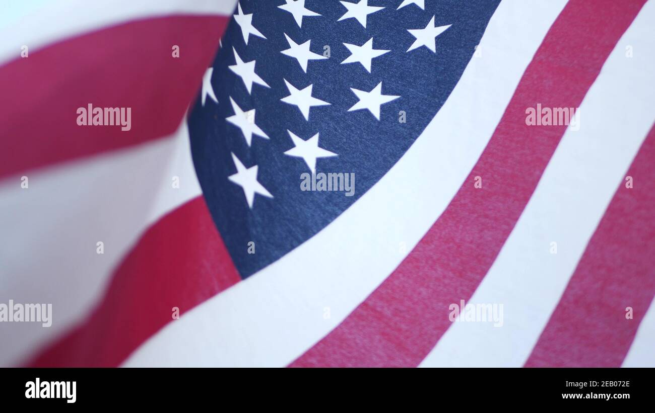 Soft focus close up of American Old Glory flag waving on wind. Stars ...