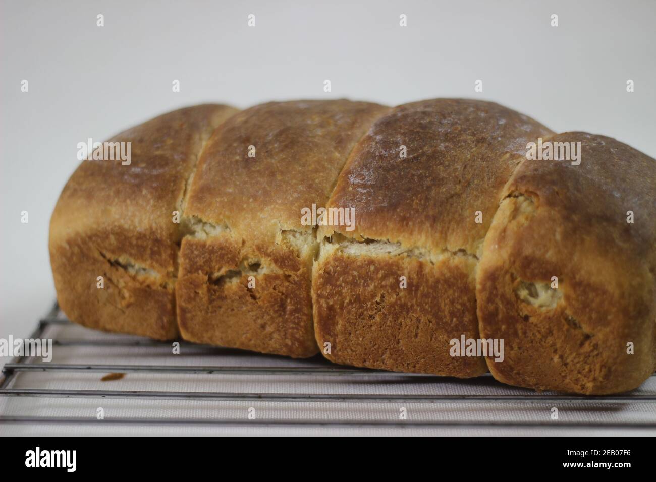 Home-baked mini roll loaf bread with broken bands of rolls visible ...