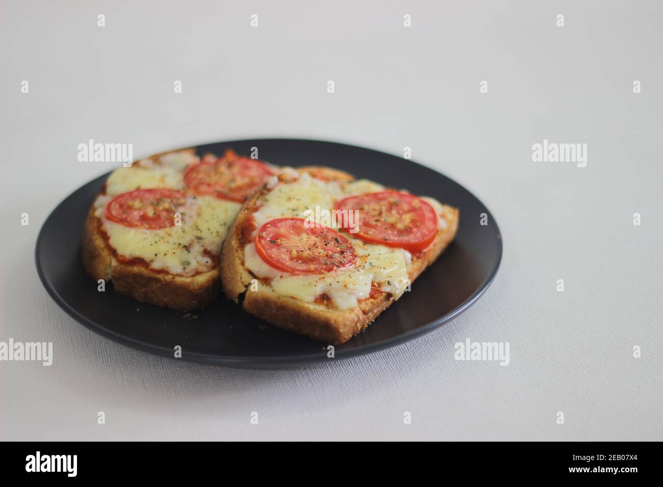 Pizza toast with home baked bread loaf. Shot on white background Stock ...