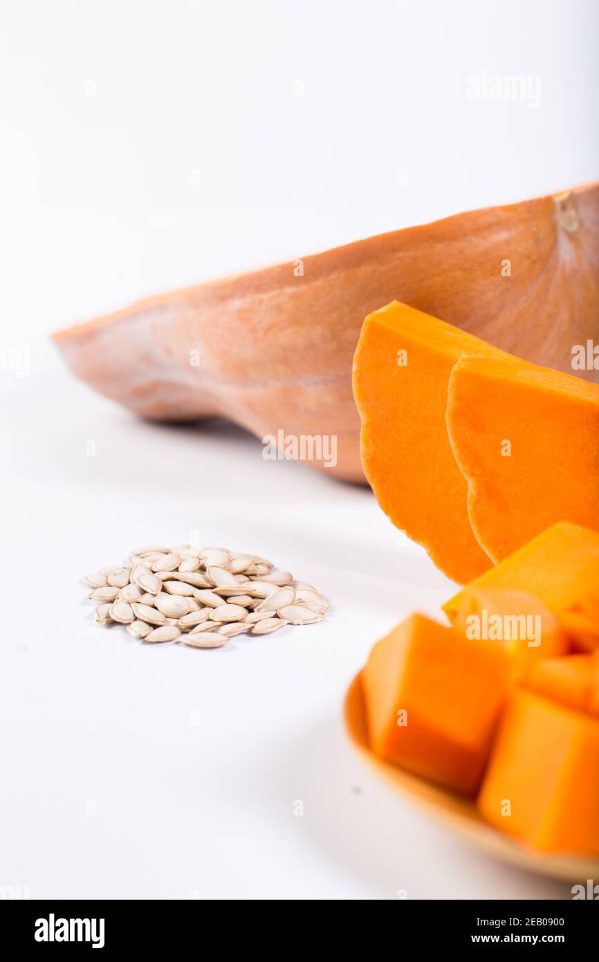 Seeds and pulp of pumpkin different size, close-up, on a white ...