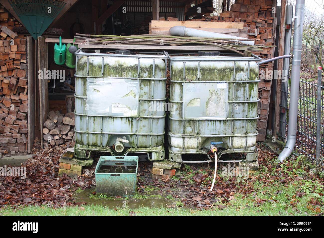 View of two water storage tanks in an old backyard Stock Photo - Alamy