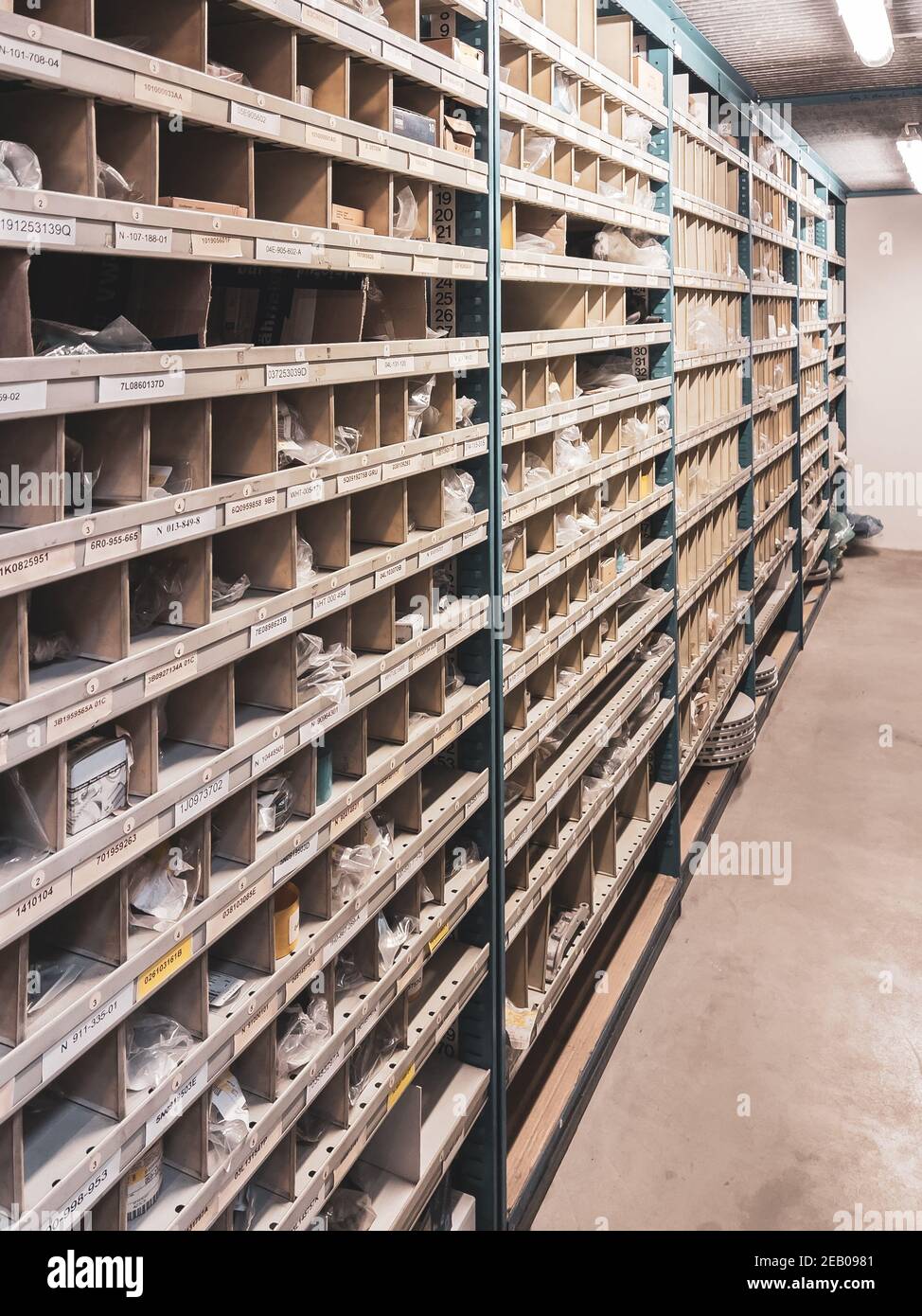 many shelves filled with spare parts stand in the parts store of the ...