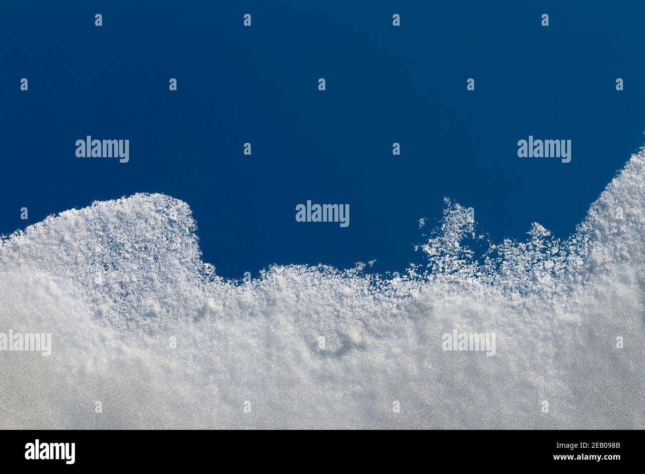 an area of powder snow against a blue sky Stock Photo - Alamy