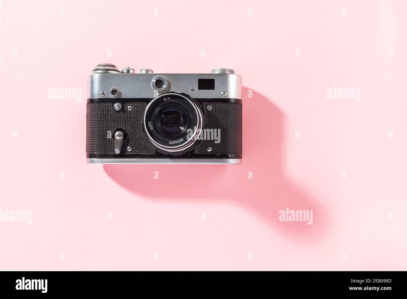 Old film photo camera on a bright pink background Stock Photo - Alamy