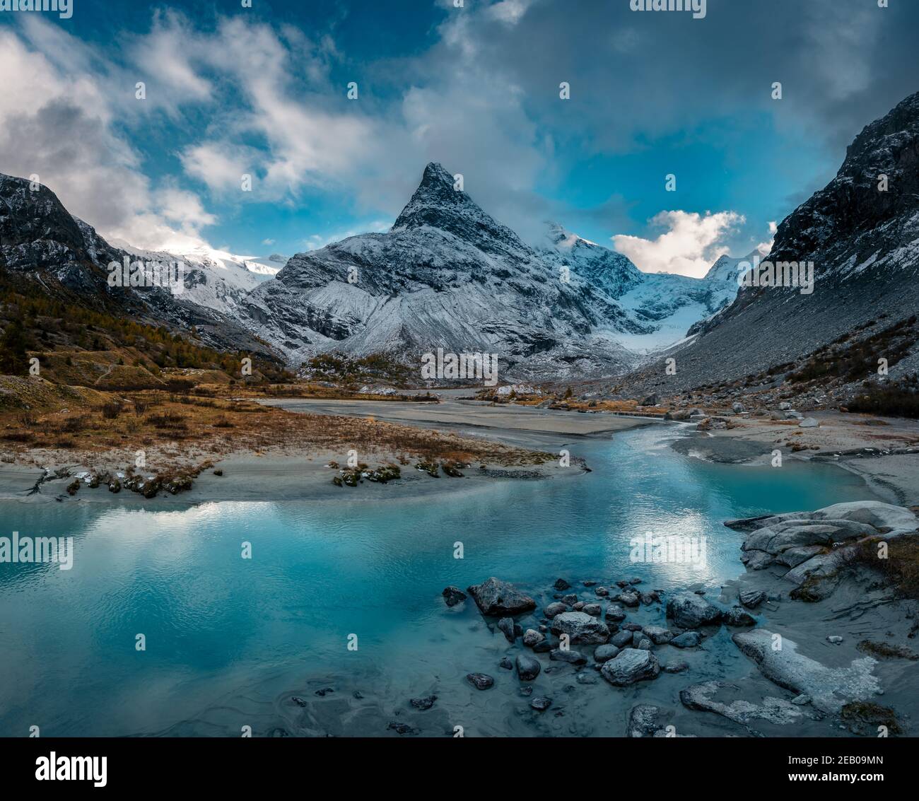 wild meandering glacial river in Ferpecle, with impressive peak of Mont ...