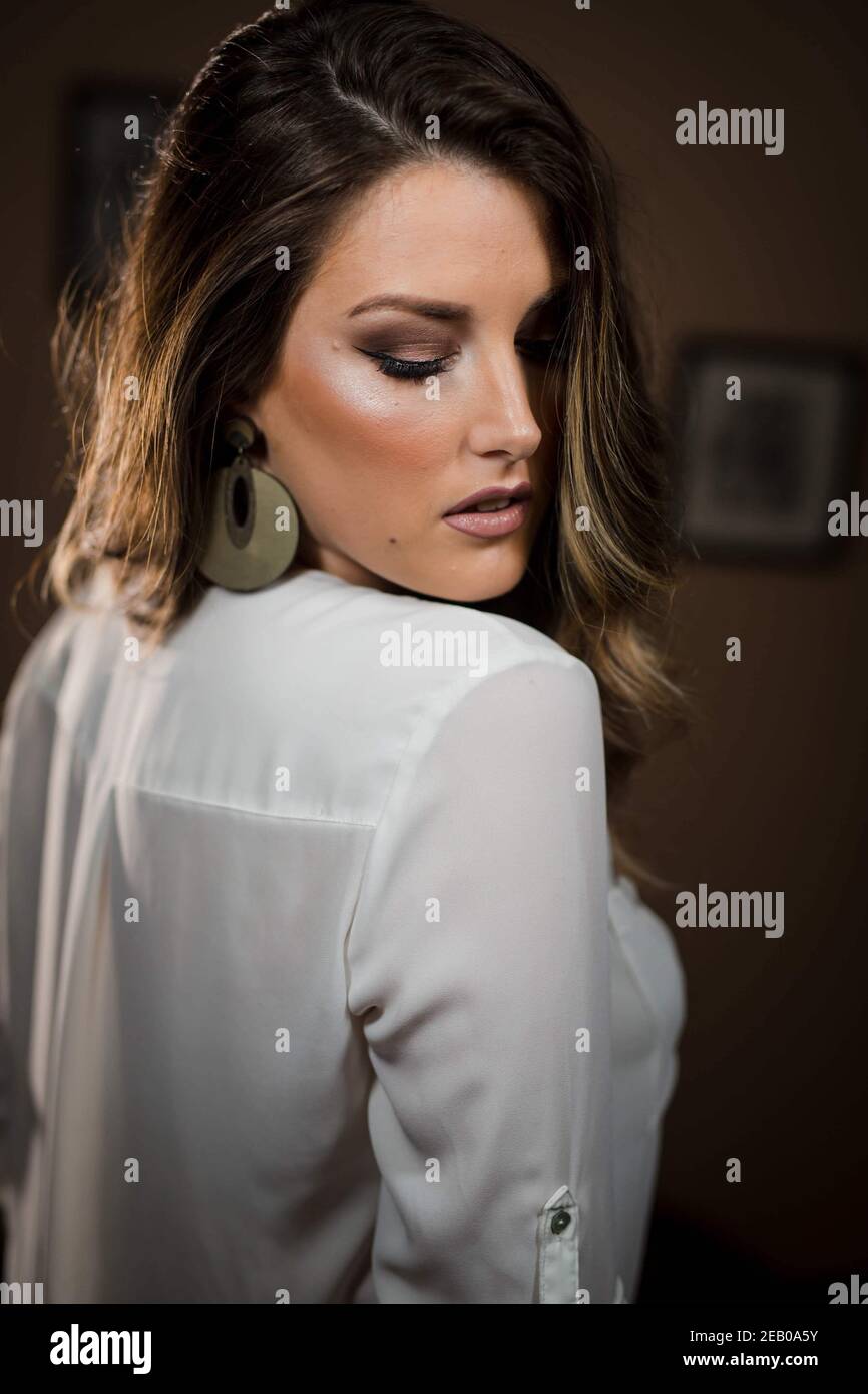 Vertical closeup of a beautiful female looking back down over a ...