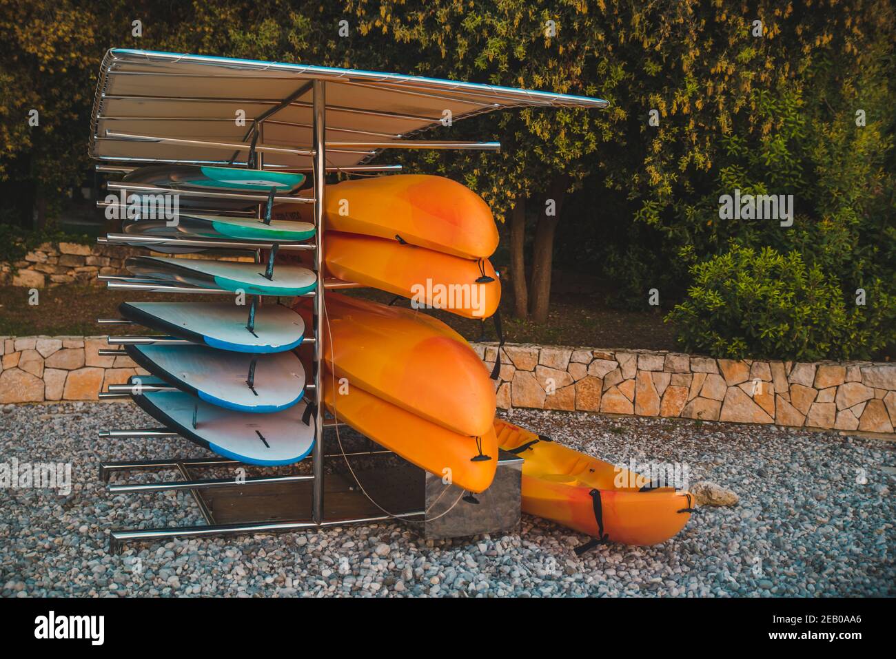 surf boards and kayaks at sea beach. summer time Stock Photo - Alamy