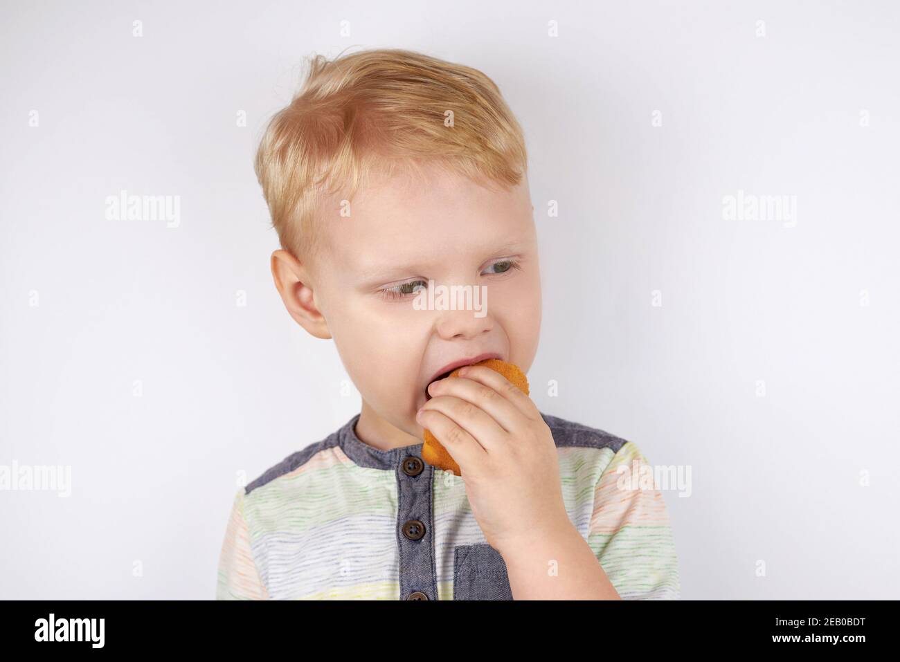 Three-year-old funny boy eats a pie on a white background Stock Photo ...