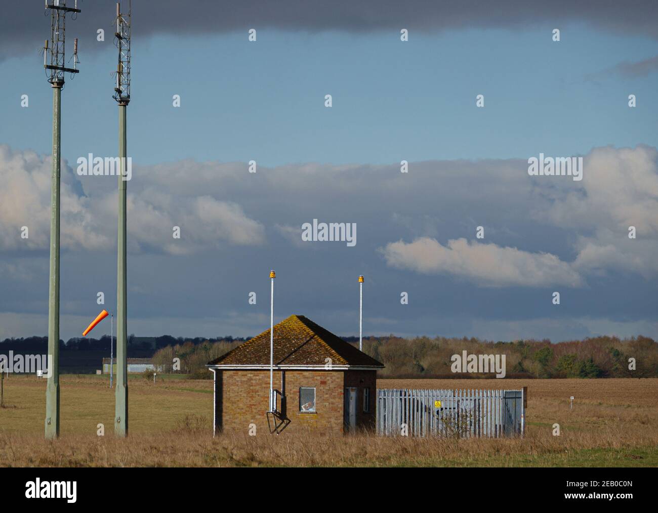 radio transmitter building with tall aerial masts at the end of an ...