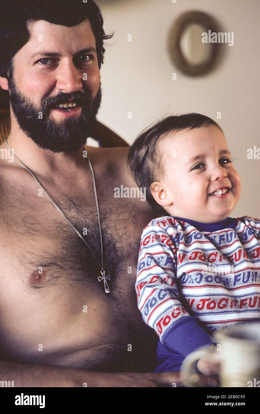 Bearded young father with his baby son, USA 1980s Stock Photo - Alamy