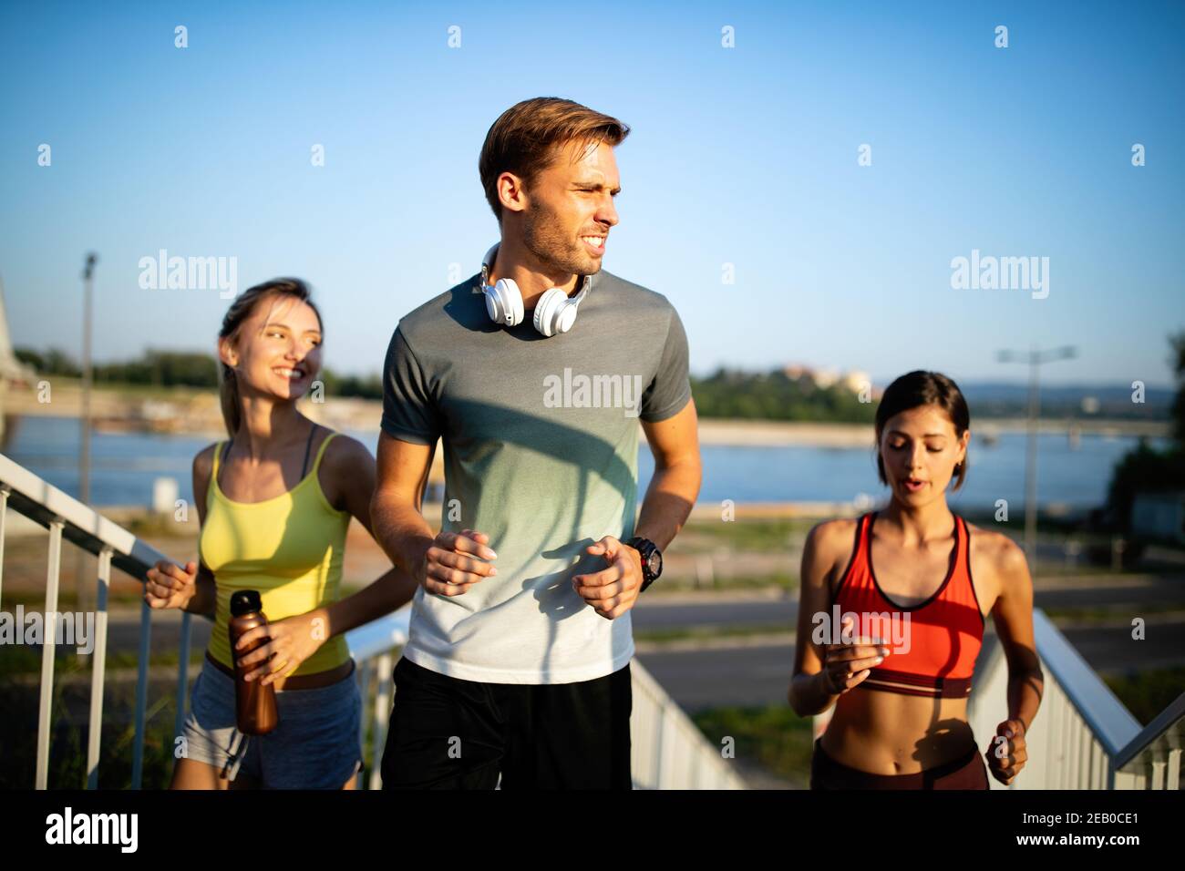 Fit happy friends jogging and running together outdoor in city Stock ...