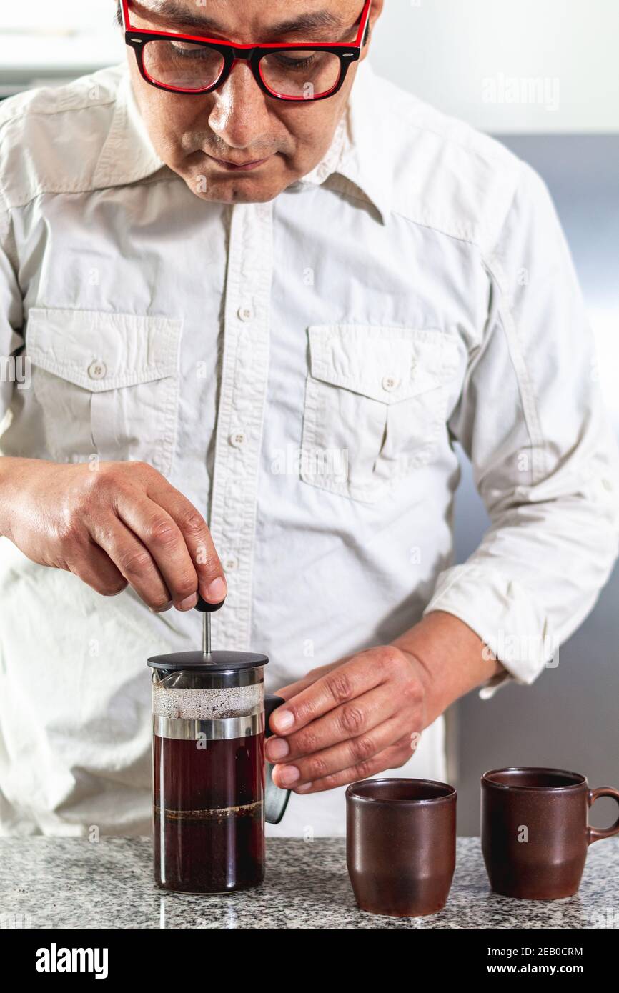 Man brewing two cups of coffee in a French press Stock Photo - Alamy