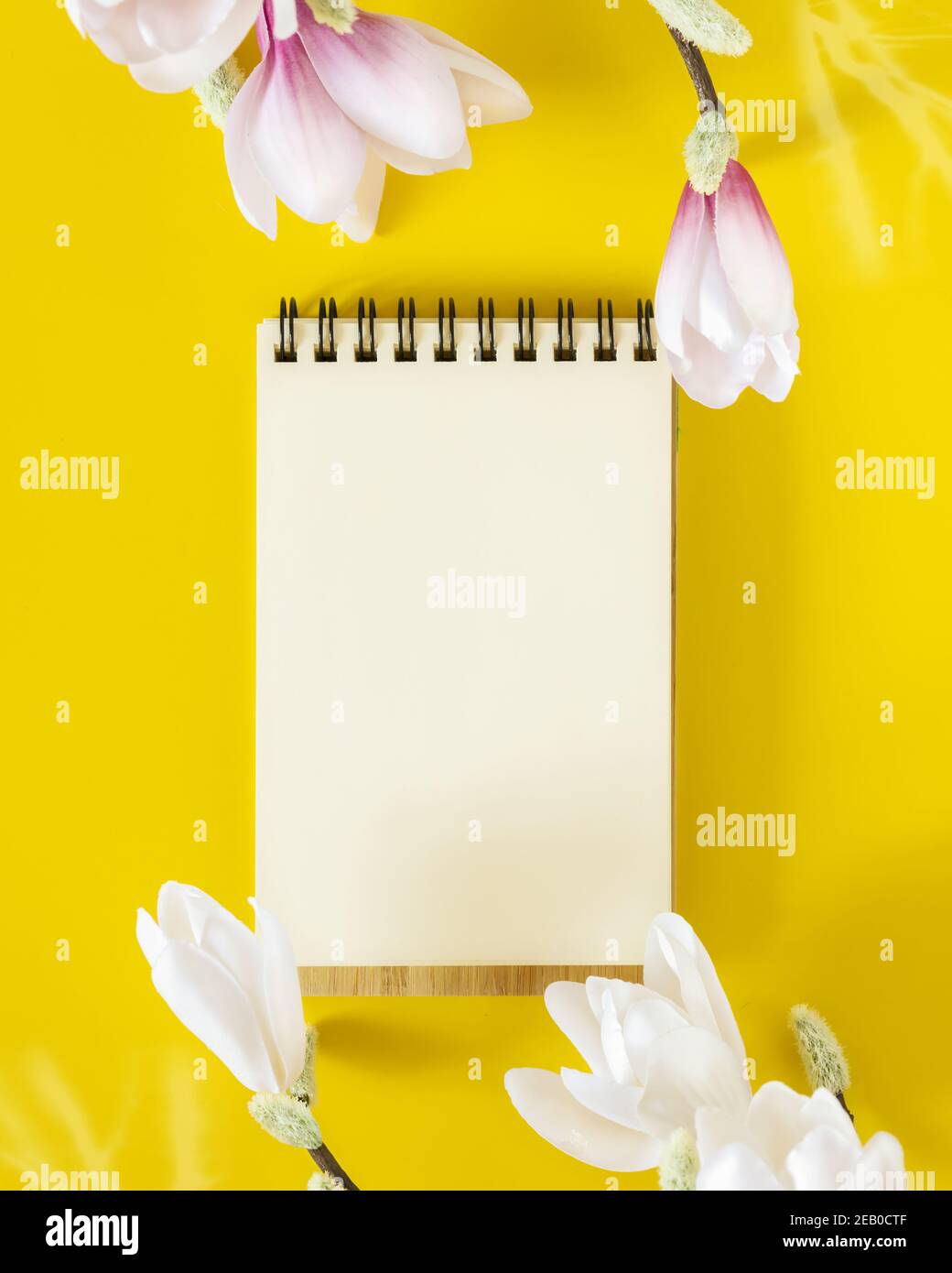 Flat lay composition with an open notebook with a white blank sheet of ...