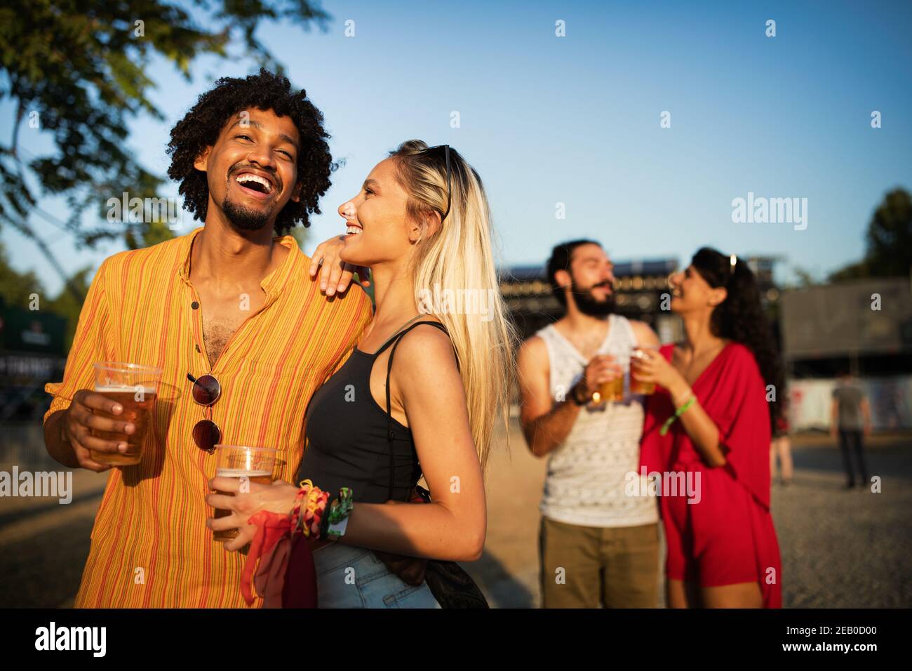Group of happy friends drinking outdoors before festival Stock Photo ...